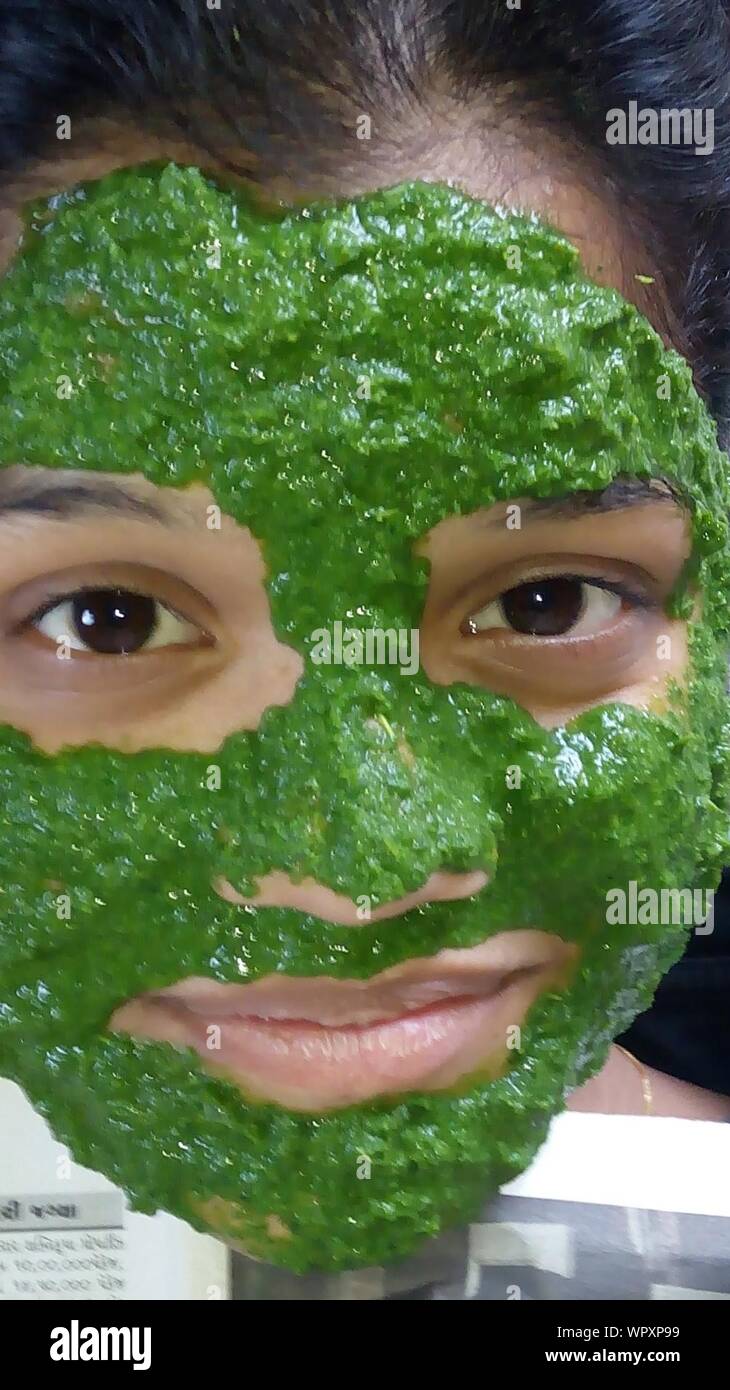 Smiling young woman green facial mask hi-res stock photography and ...