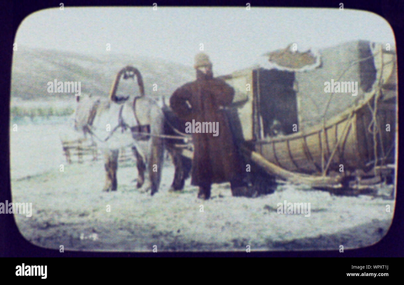 Man standing beside horse-drawn carriage sledge Stock Photo - Alamy