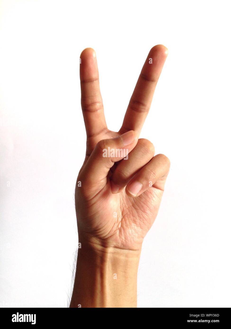 Man showing fingers victory hand hi-res stock photography and images ...