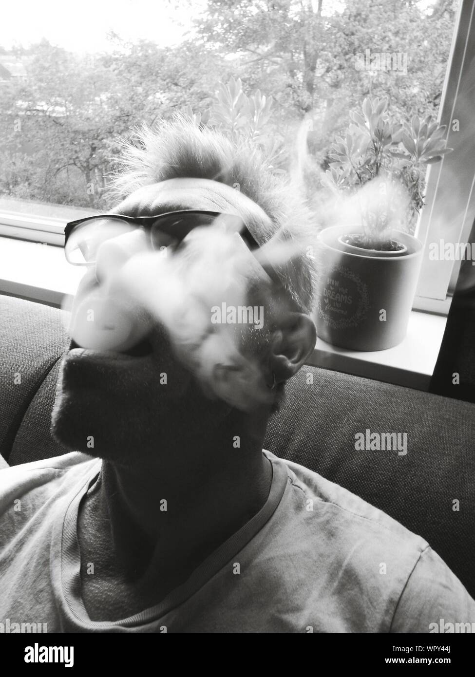 Man sitting smoking hi-res stock photography and images - Alamy