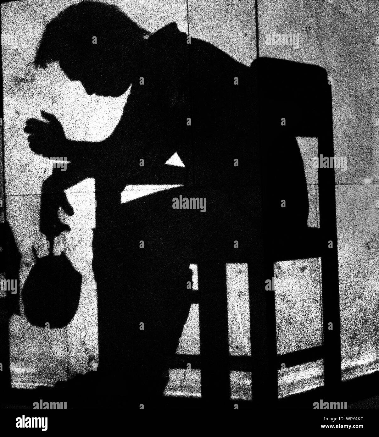 Shadow of man sitting hi-res stock photography and images - Alamy