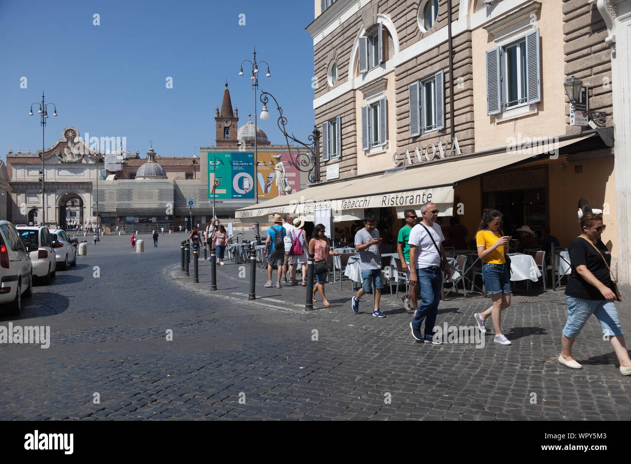 Lunch at Tabacchi Ristorante with pedestrians and cars on cobblestone ...