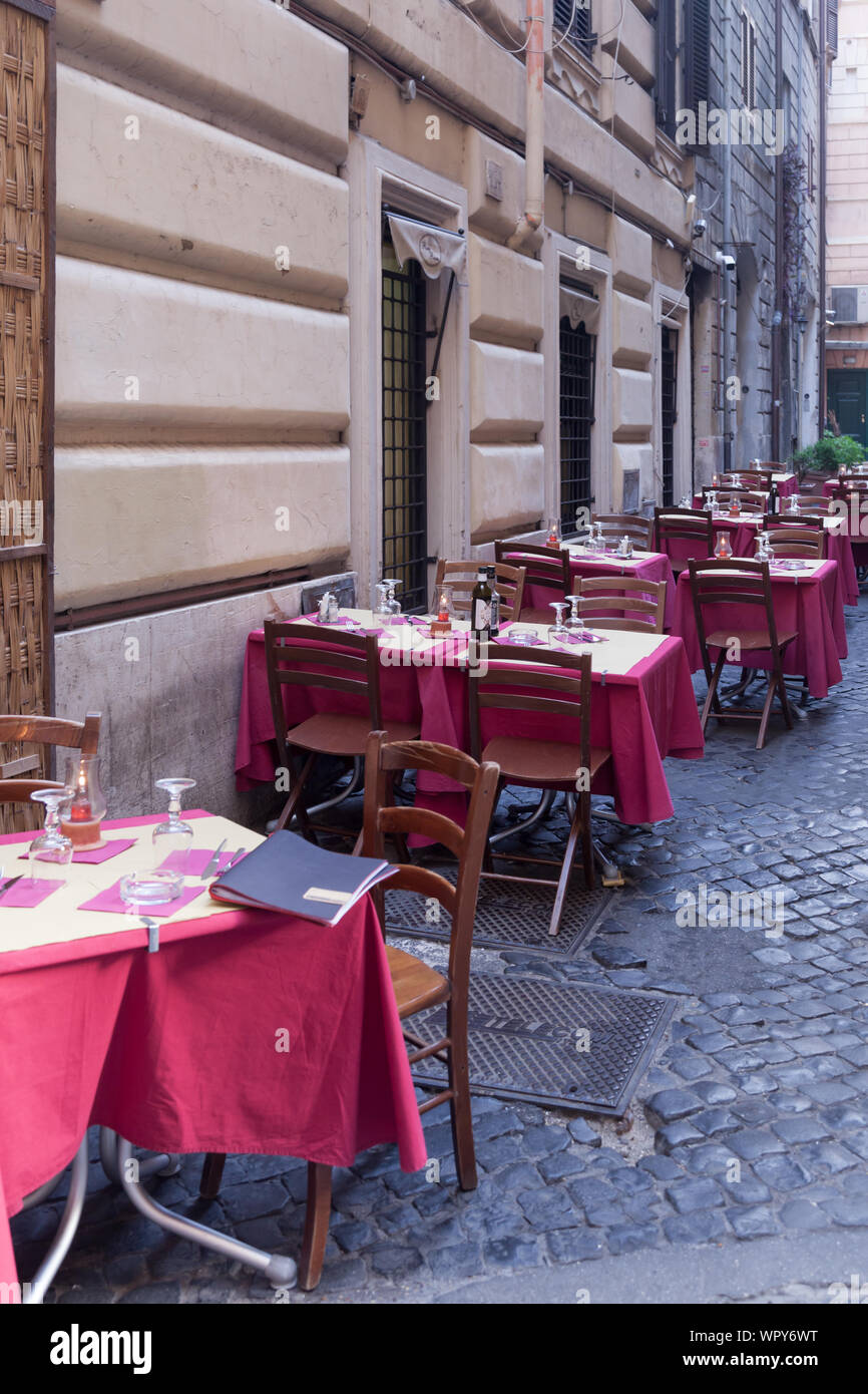Restaurant with outdoor tables on cobblestone street. Rome, Italy Stock ...
