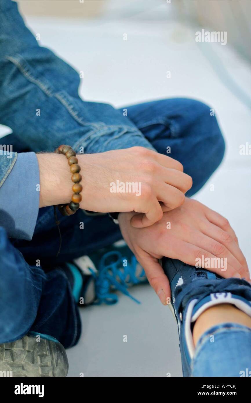 Hand touching shoe hi-res stock photography and images - Alamy