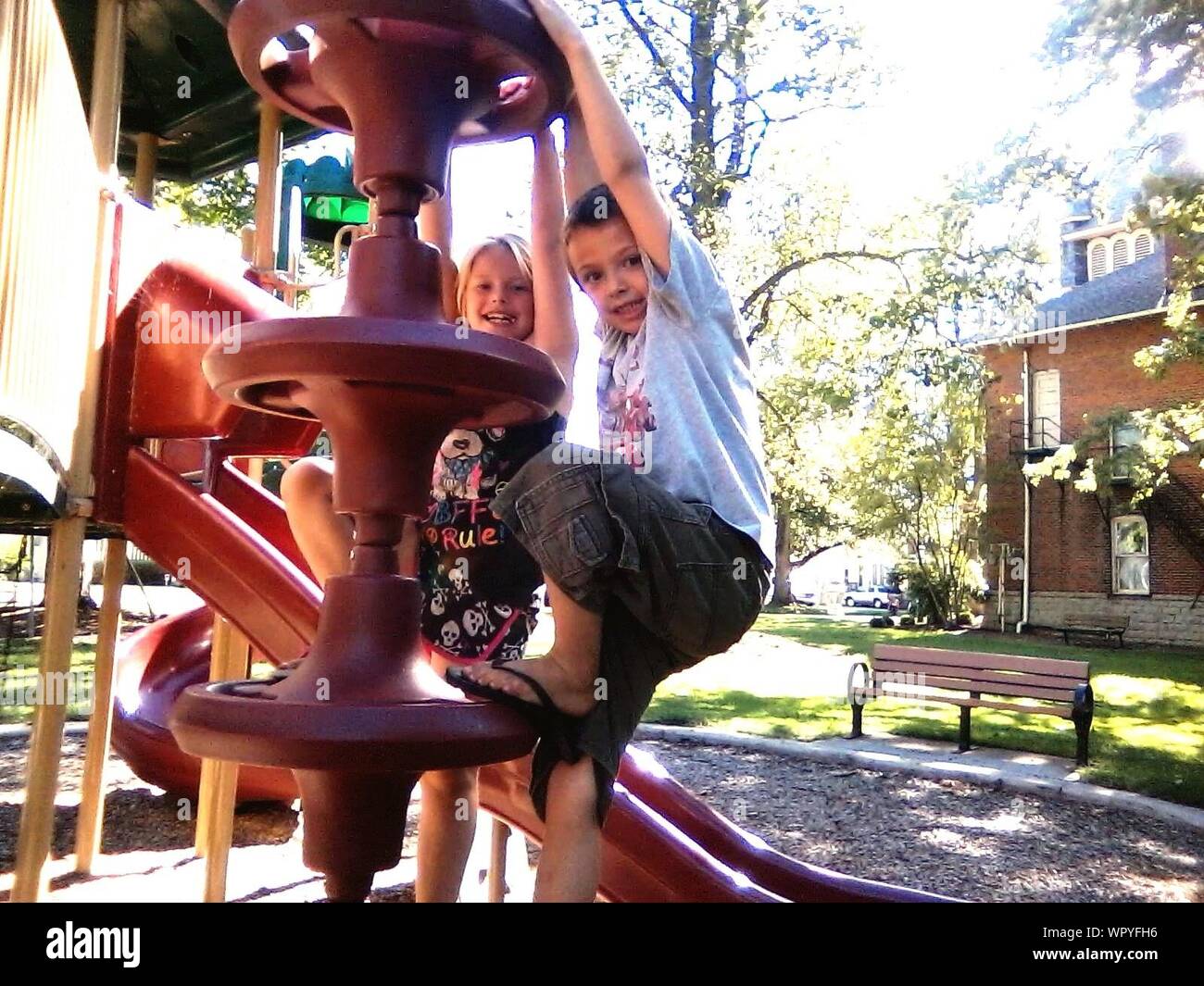 Kids playing on slide hi-res stock photography and images - Alamy