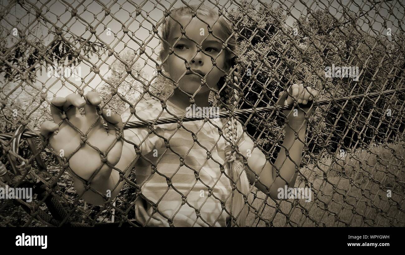 Girl behind fence hi-res stock photography and images - Alamy