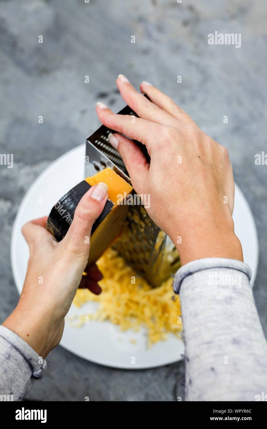 Woman grating cheese hi-res stock photography and images - Alamy