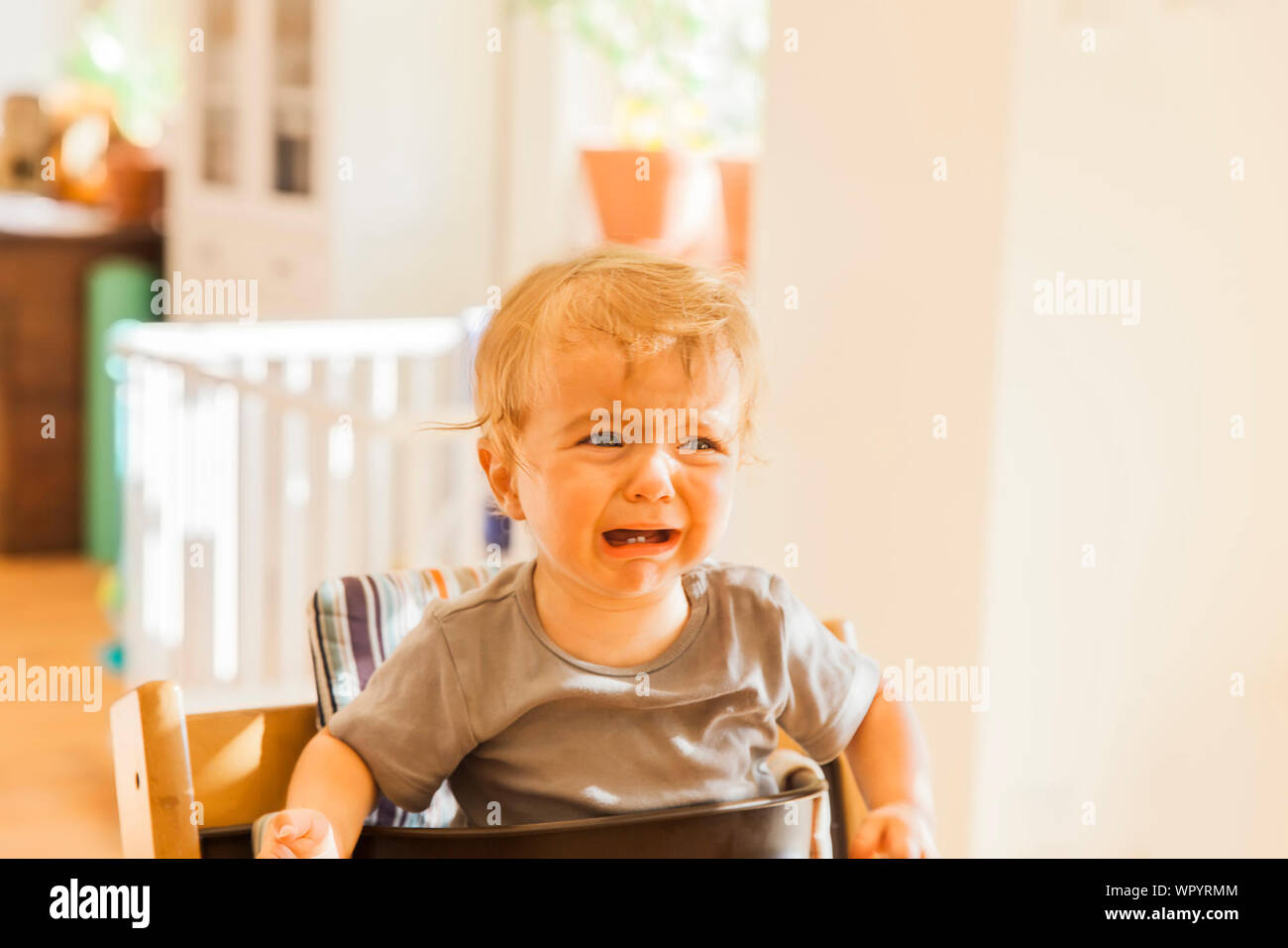 Toddler crying in chair hi-res stock photography and images - Alamy