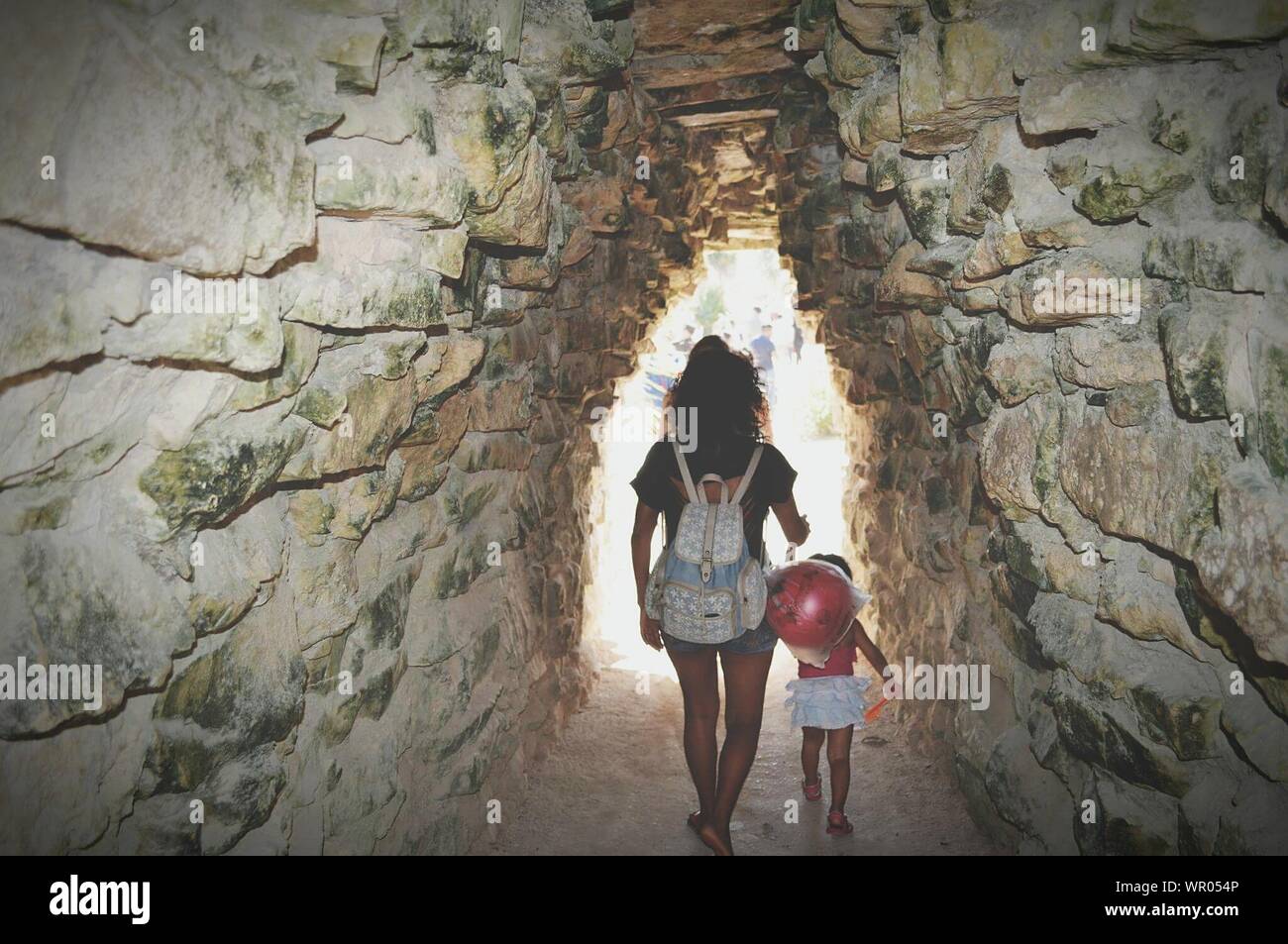Woman walking in cave hi-res stock photography and images - Alamy