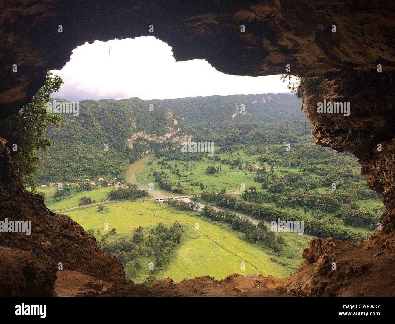 Green Landscape Seen Through Rock Window Stock Photo - Alamy