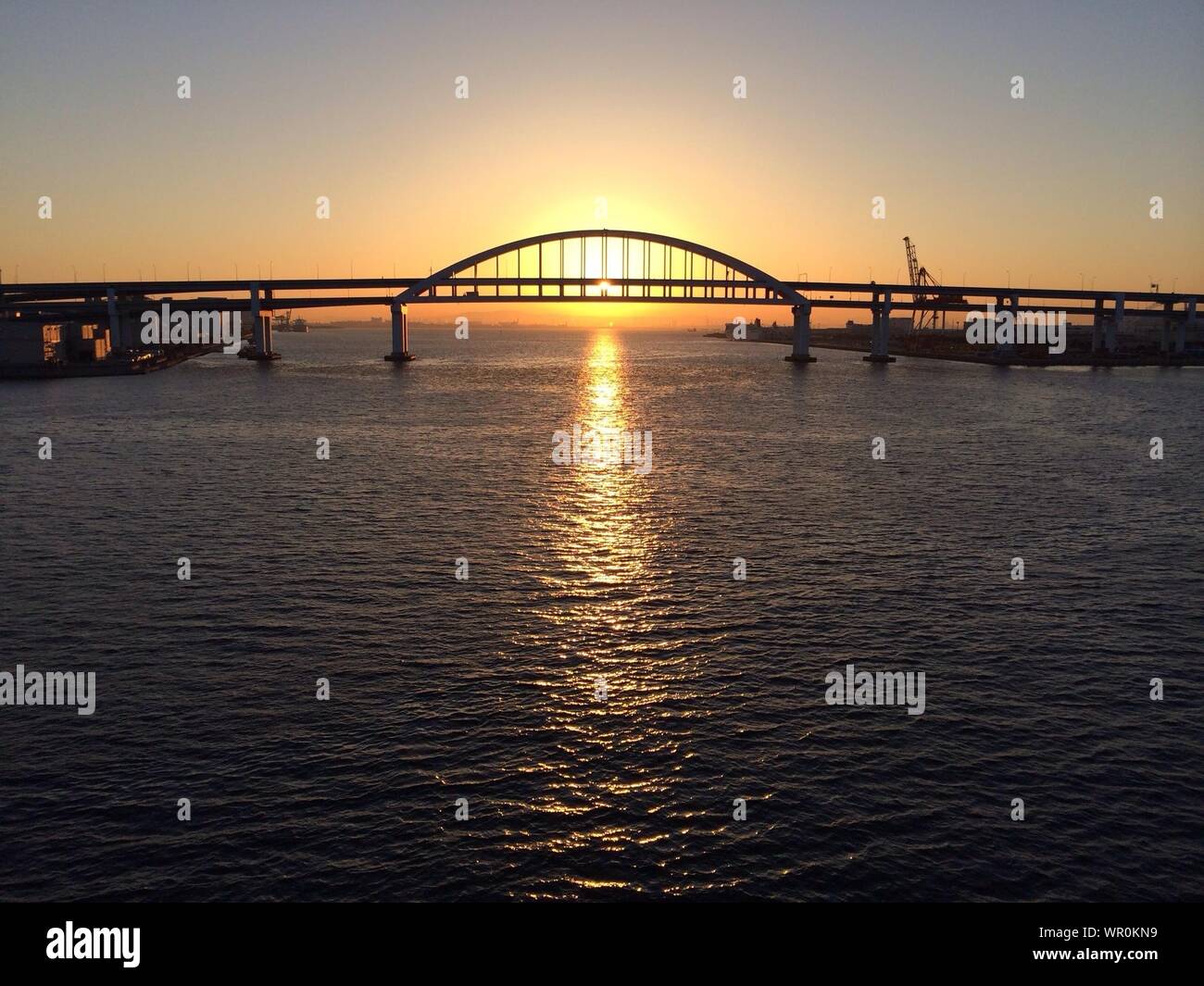 Silhouette Bridge Against Orange Sky Stock Photo - Alamy
