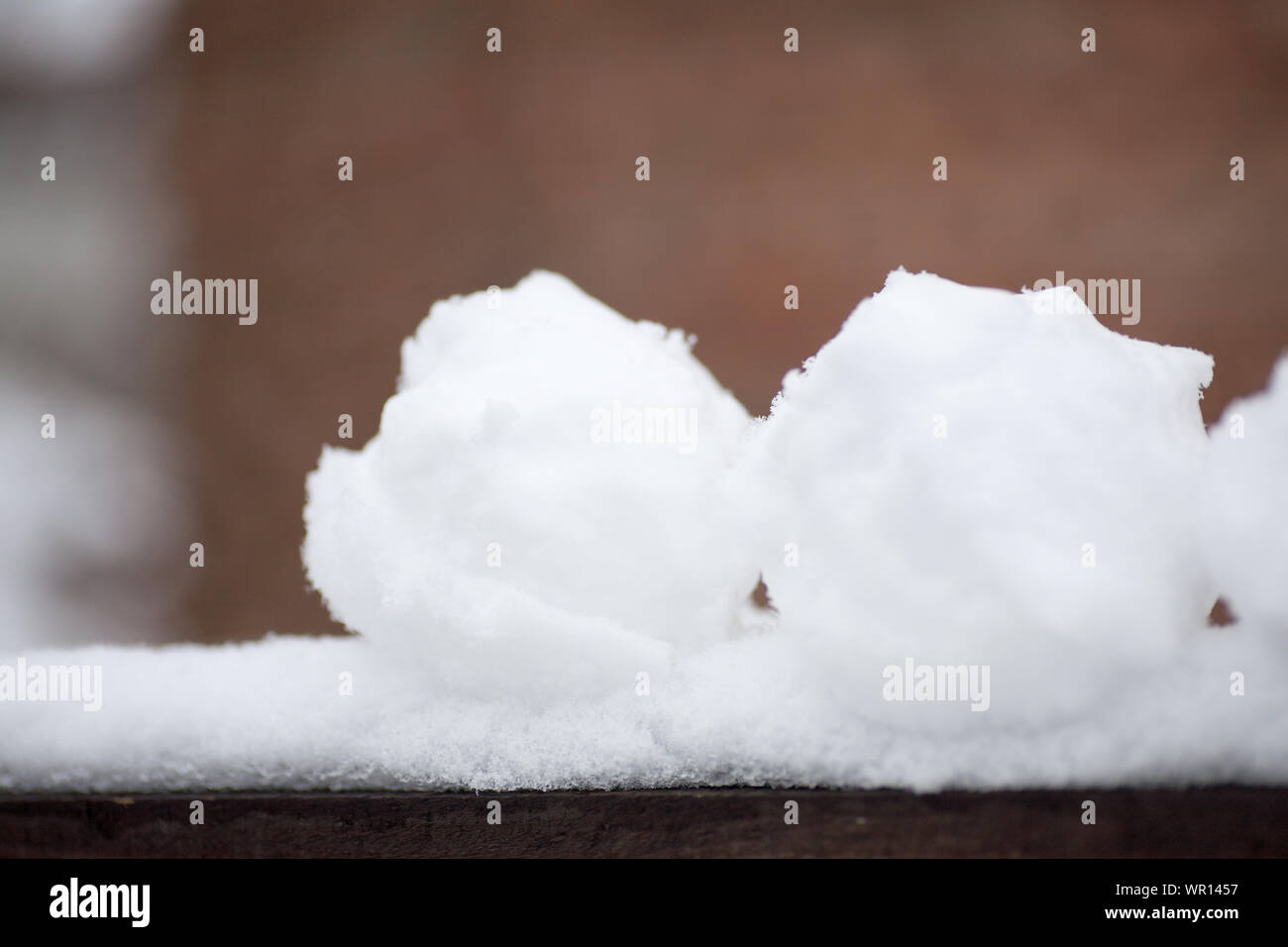 real snowballs with their hands clasped from the fresh snow in winter ...