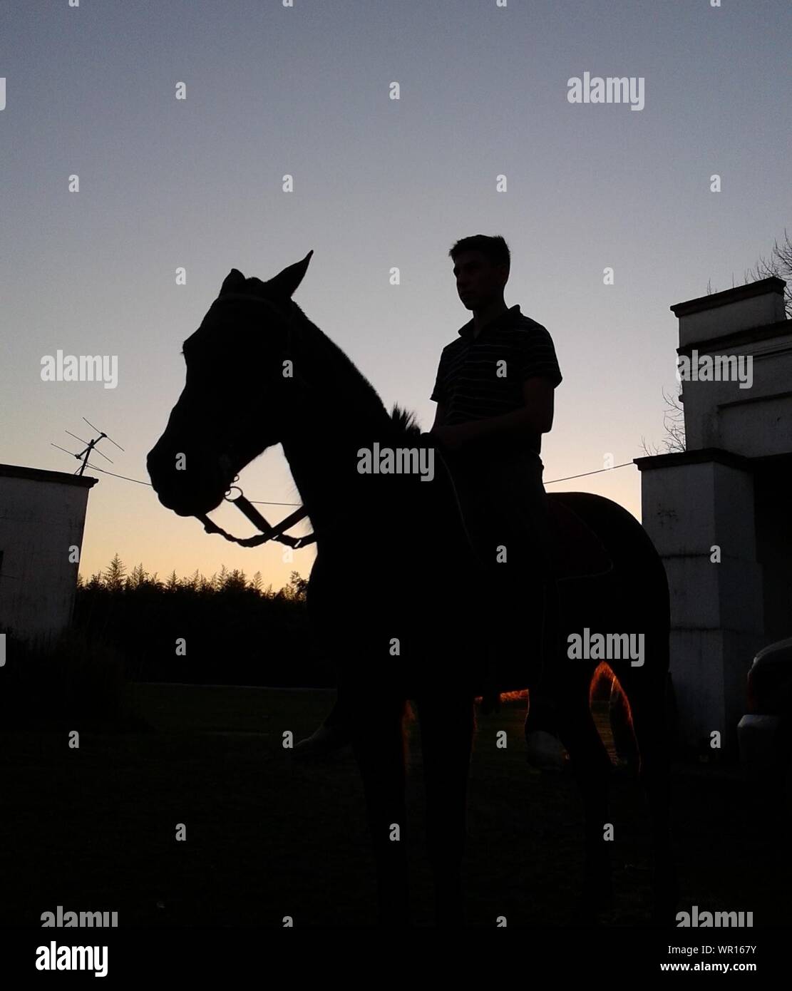Silhouette man horse against sunset hi-res stock photography and images ...