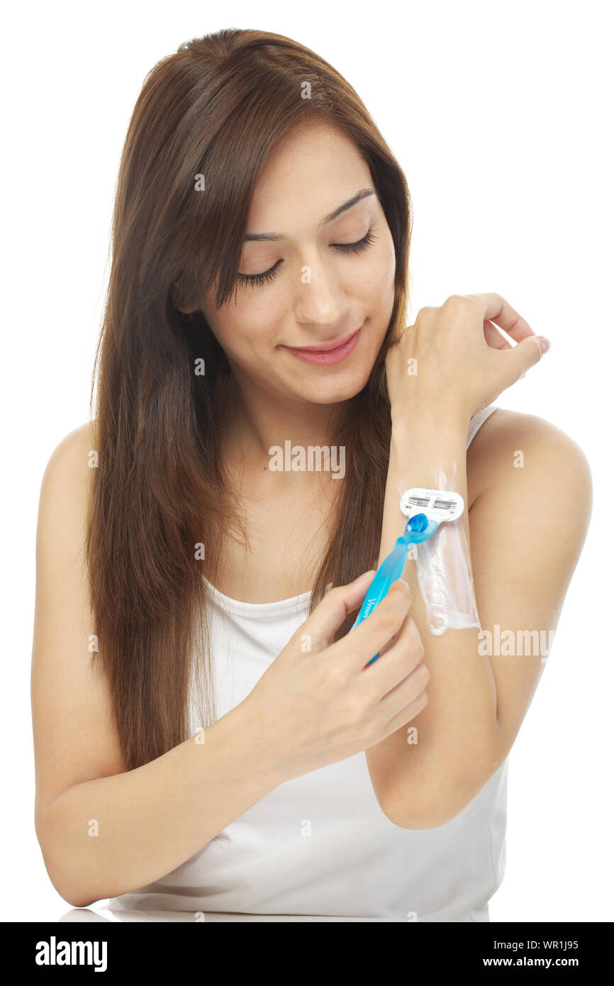 Young woman shaving her arm Stock Photo - Alamy