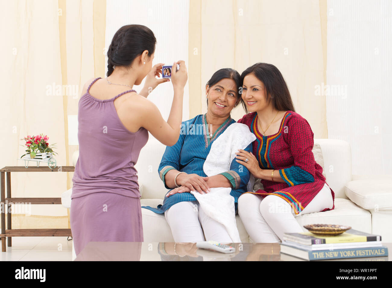 Young woman taking a picture of her parents Stock Photo - Alamy