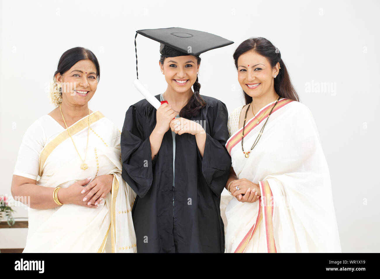 Graduate student standing with her parents and smiling Stock Photo - Alamy