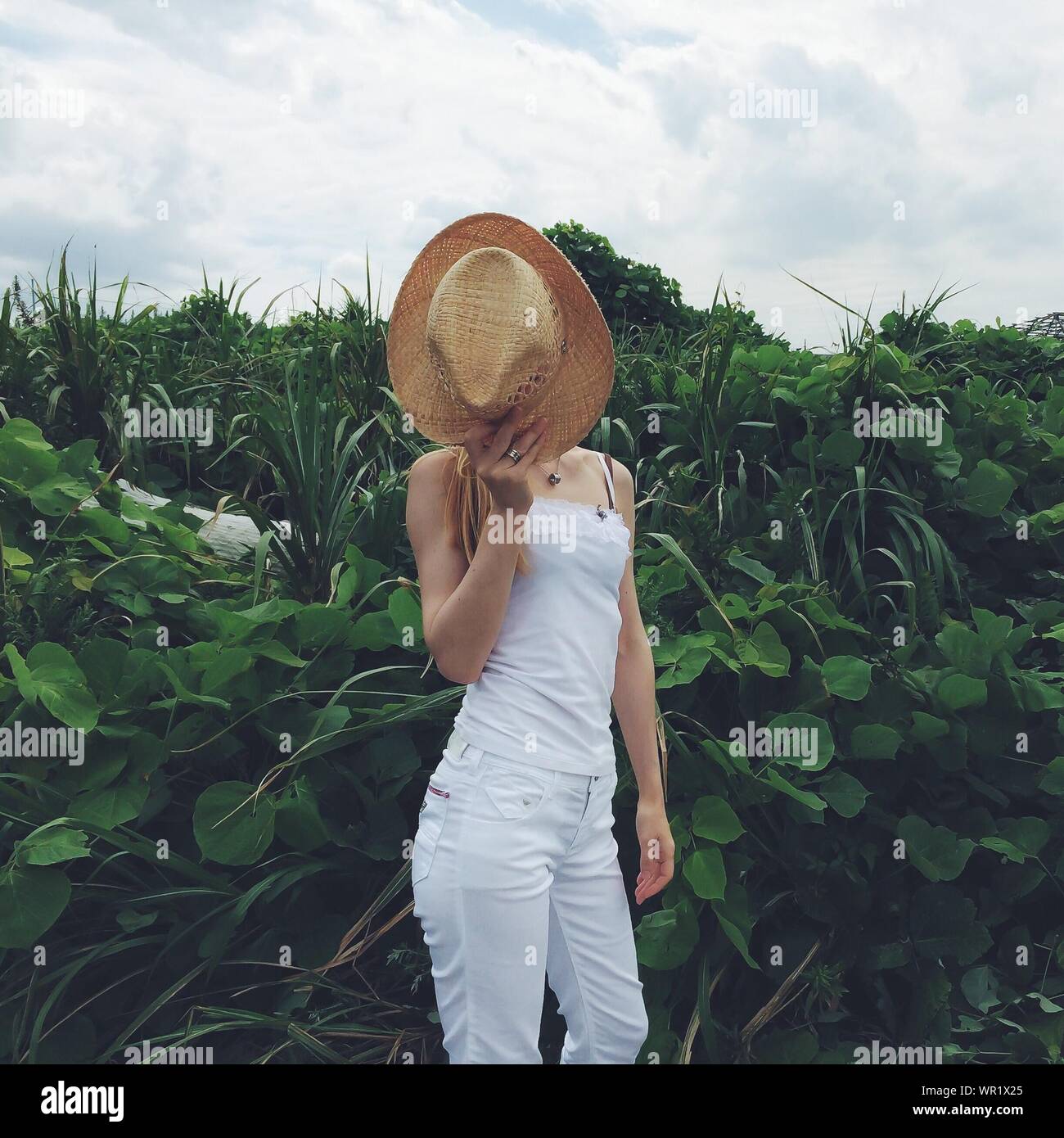 Hat covering face hi-res stock photography and images - Alamy