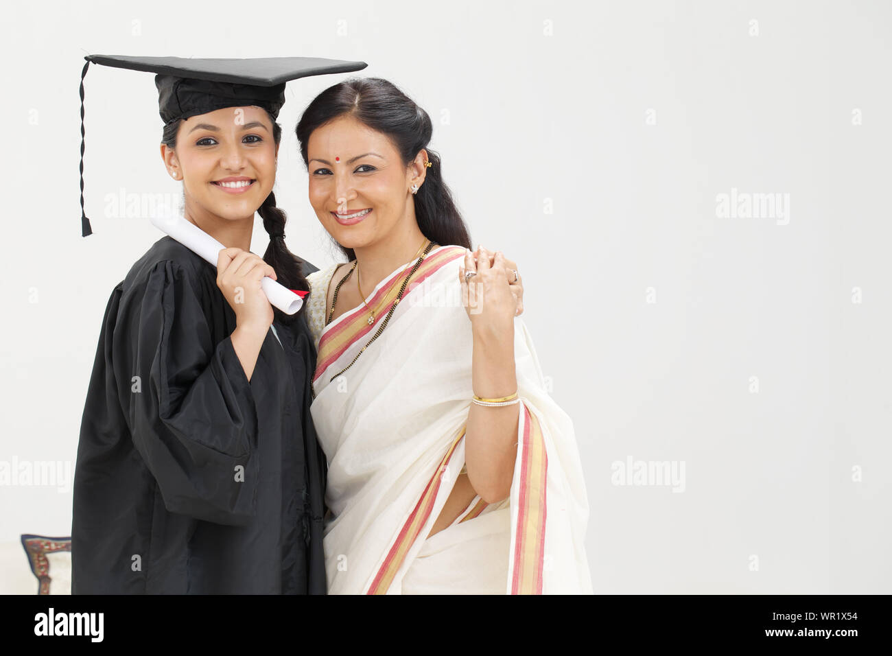 Young woman holding degree with her mother Stock Photo - Alamy