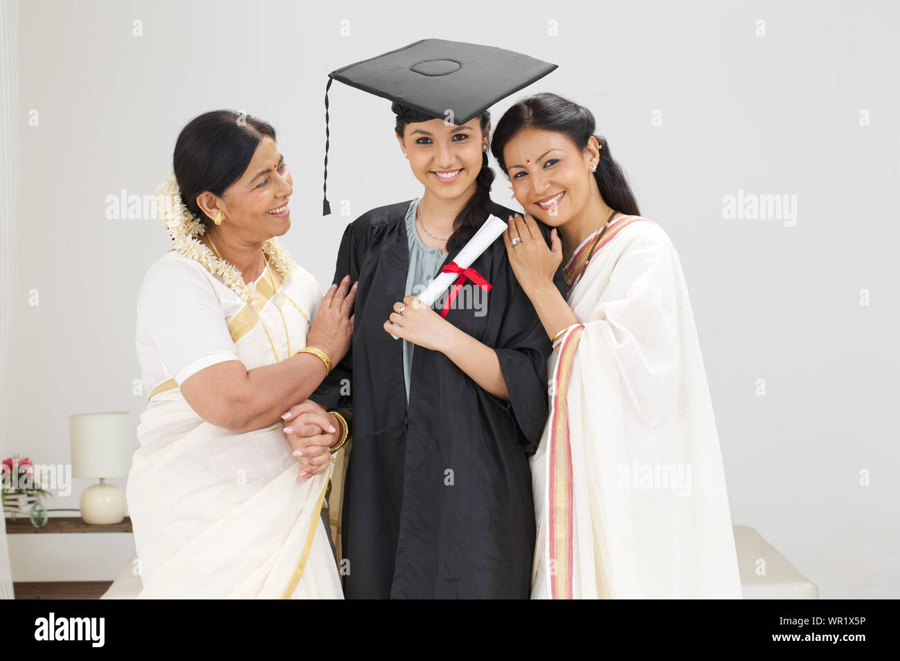Graduate student standing with her parents and smiling Stock Photo - Alamy