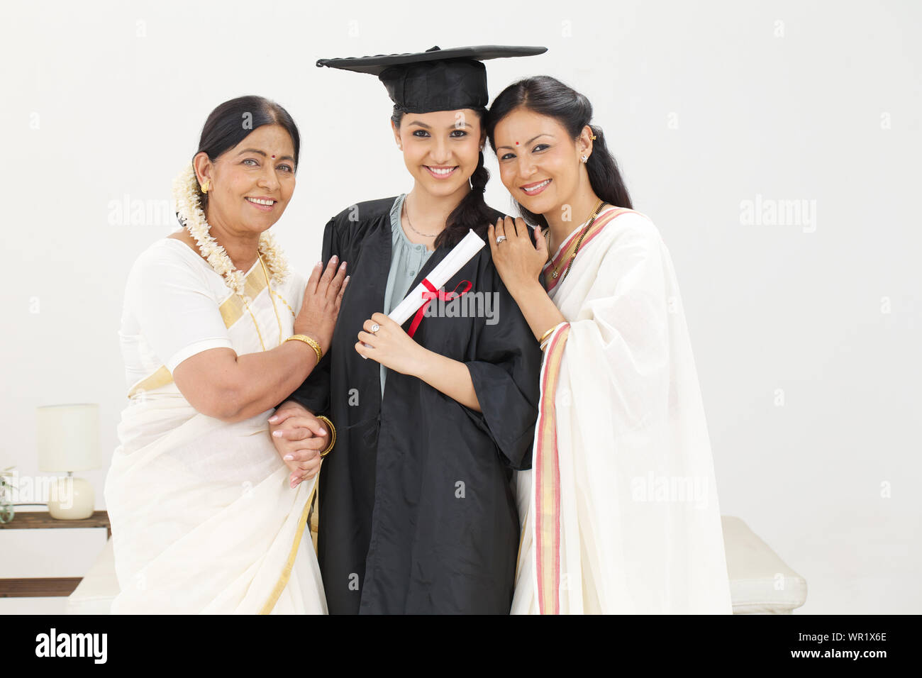 Graduate student standing with her parents and smiling Stock Photo - Alamy