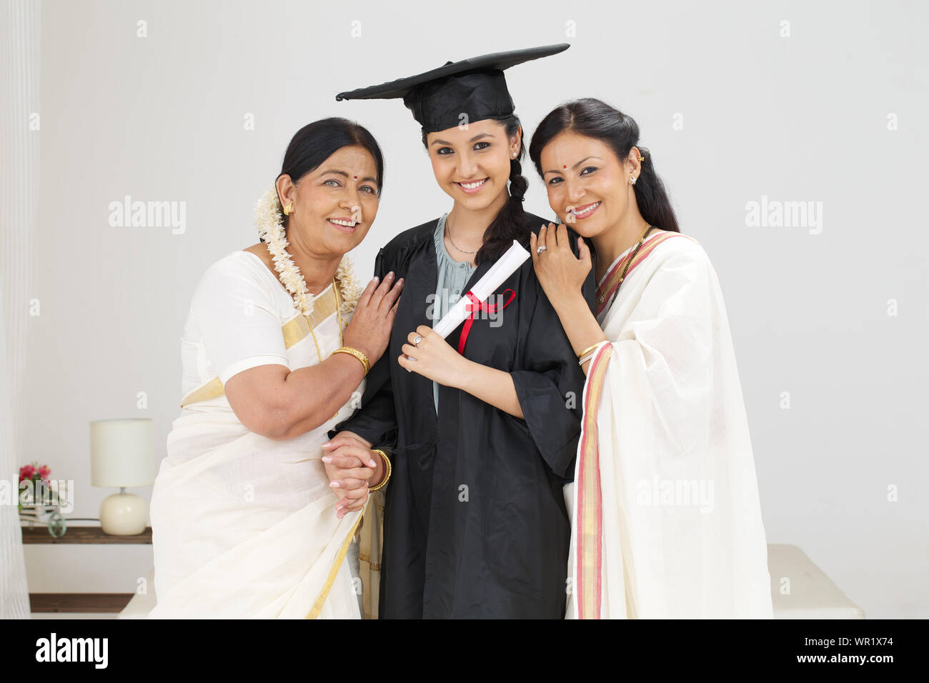 Graduate student standing with her parents and smiling Stock Photo - Alamy