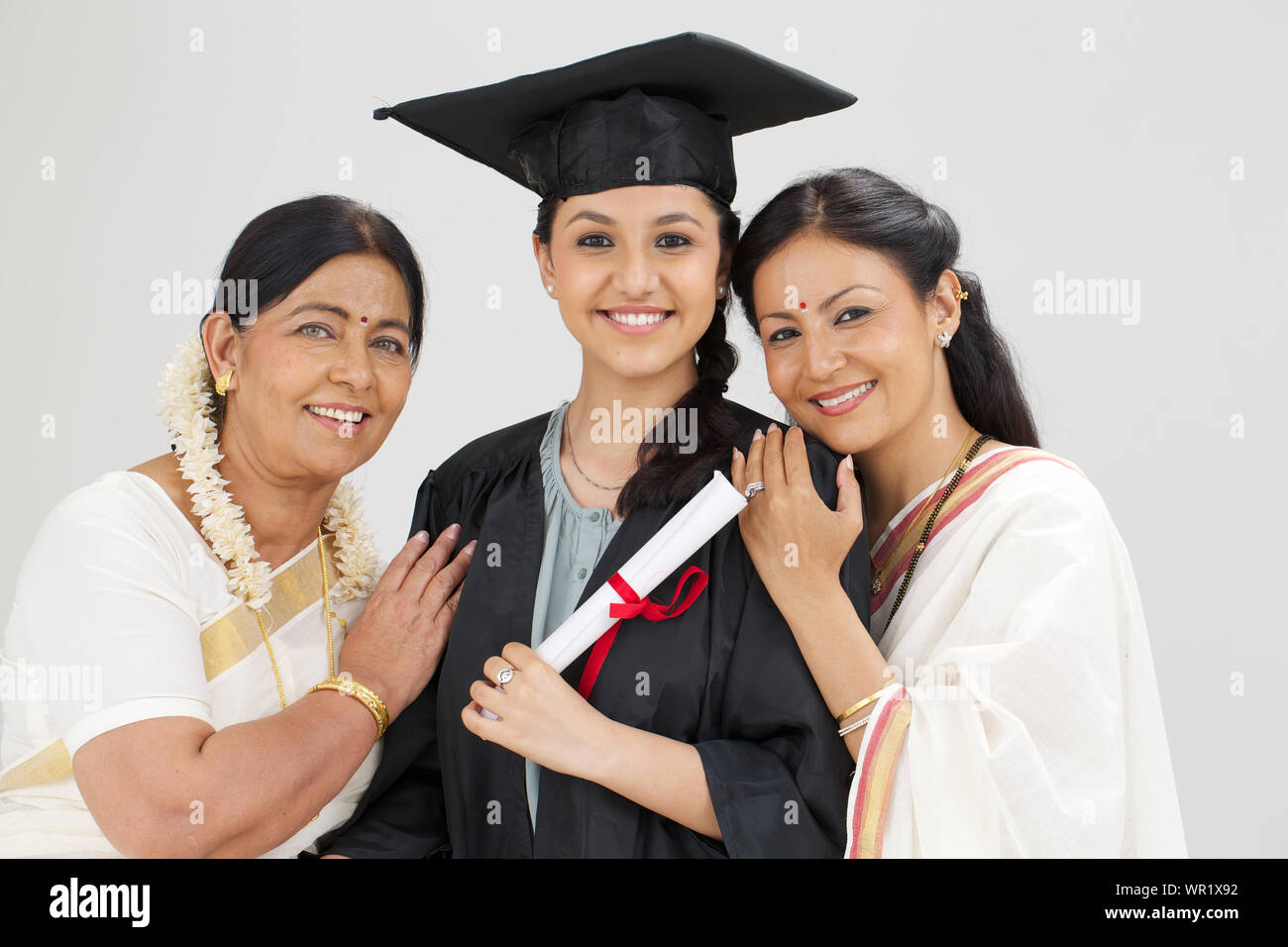 Graduate student standing with her parents and smiling Stock Photo - Alamy