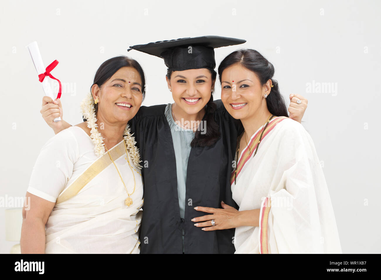 Graduate student standing with her parents and smiling Stock Photo - Alamy