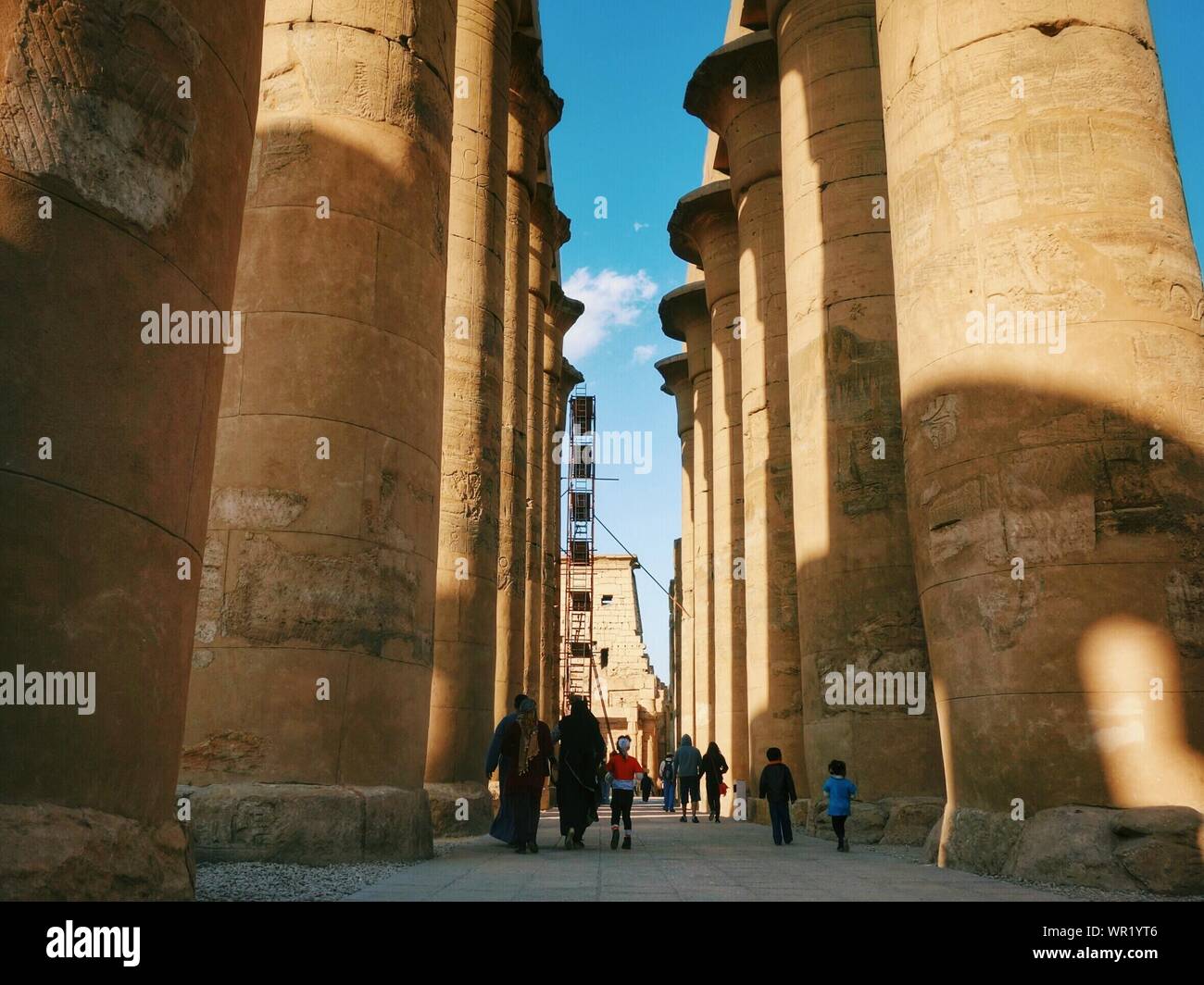 Group Of Tourist Walking By Large Columns Of Luxor Temple Stock Photo ...