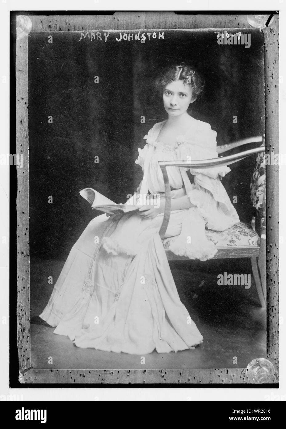 Mary Johnston, seated with magazine Stock Photo - Alamy