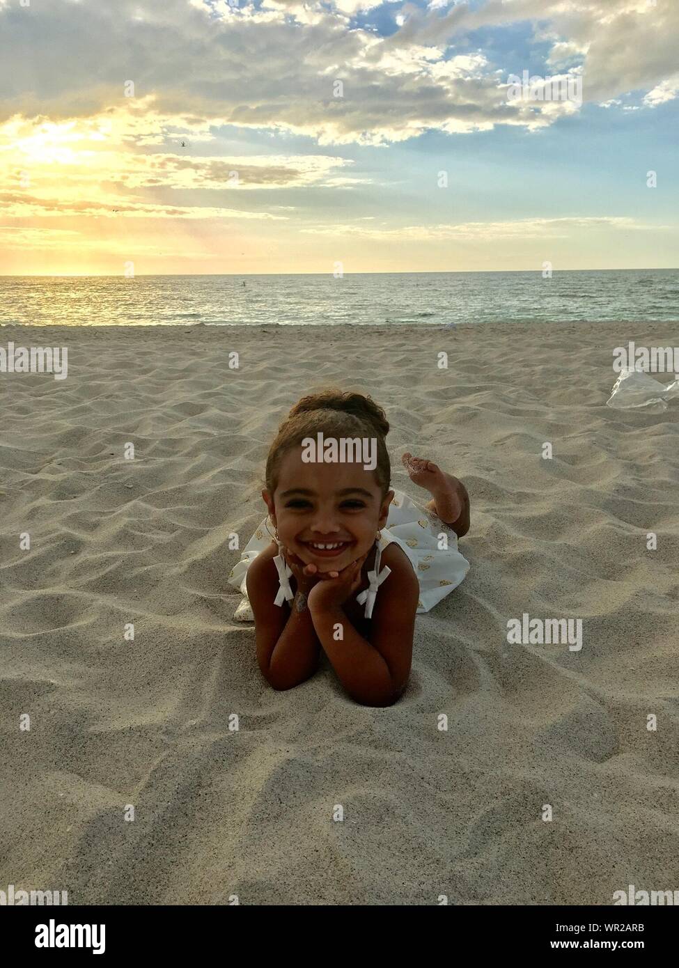 Girl lying in sand hi-res stock photography and images - Alamy