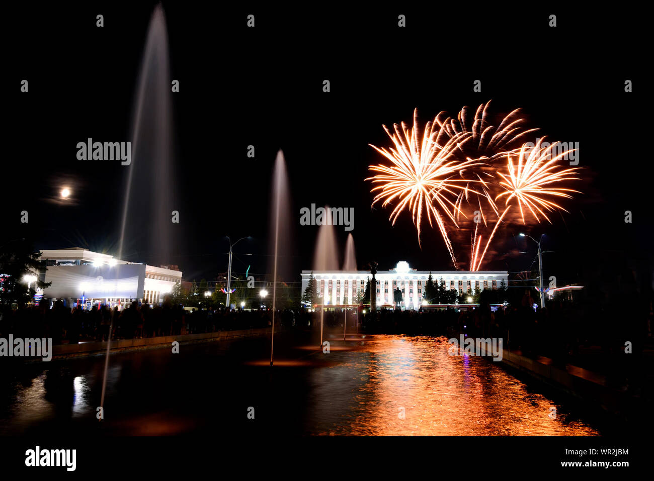 Colorful festive fireworks, salute over buildings in the city and its ...