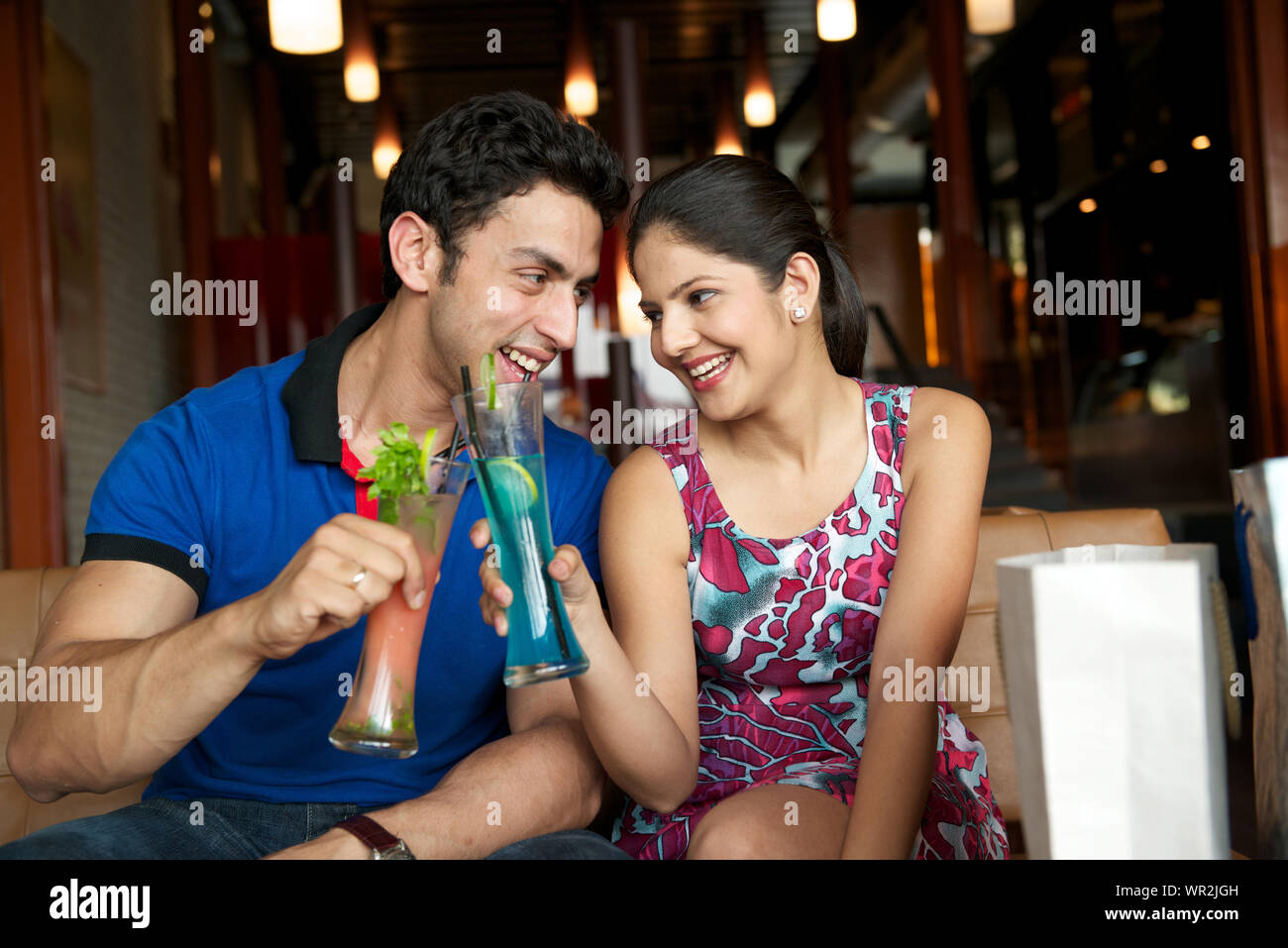 Couple having drinks in a restaurant Stock Photo - Alamy