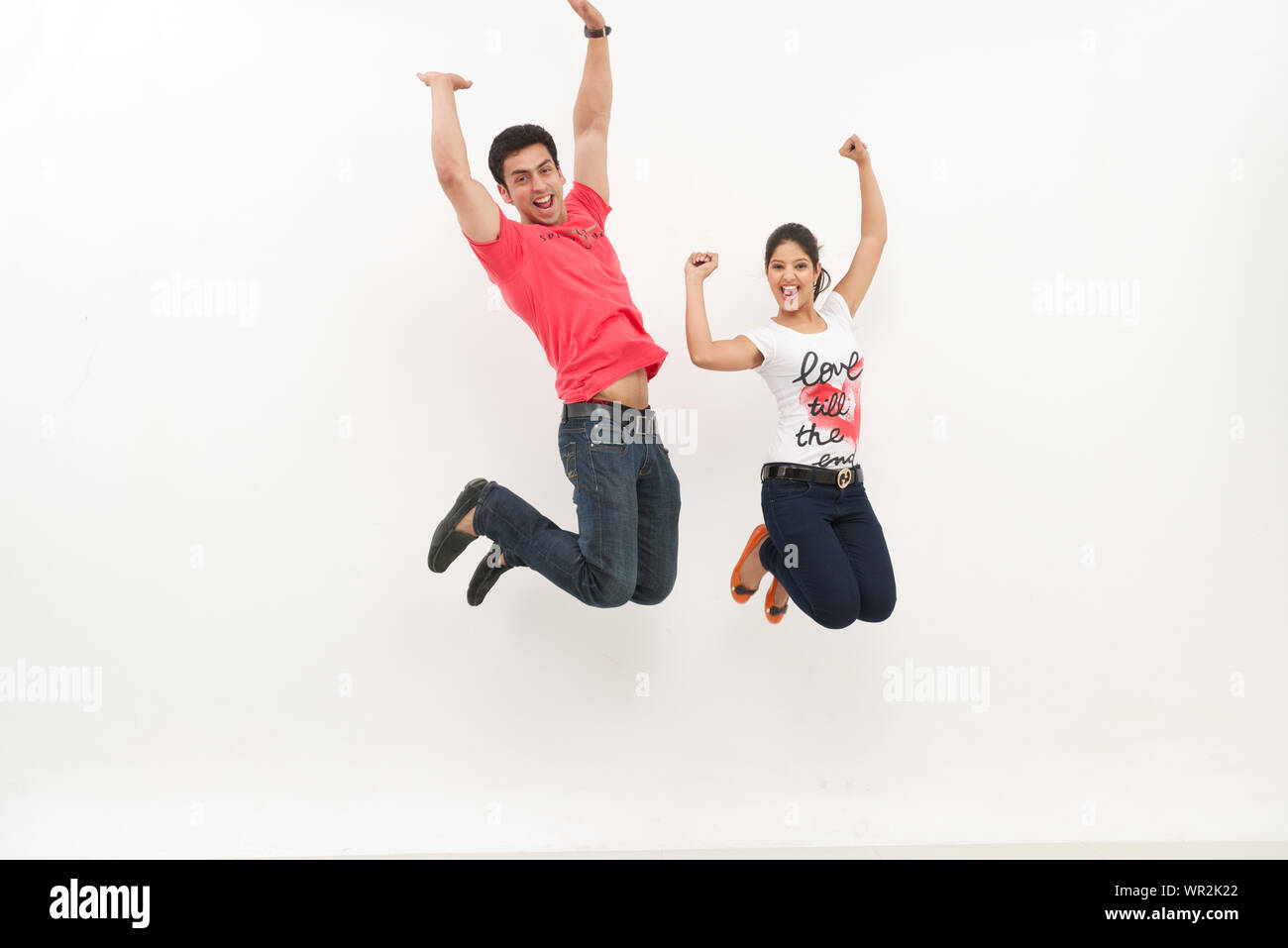 Young couple jumping in air Stock Photo - Alamy
