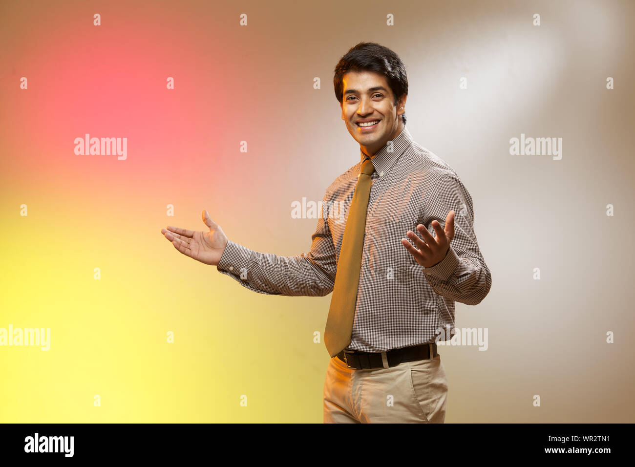 Businessman gesturing and smiling Stock Photo - Alamy