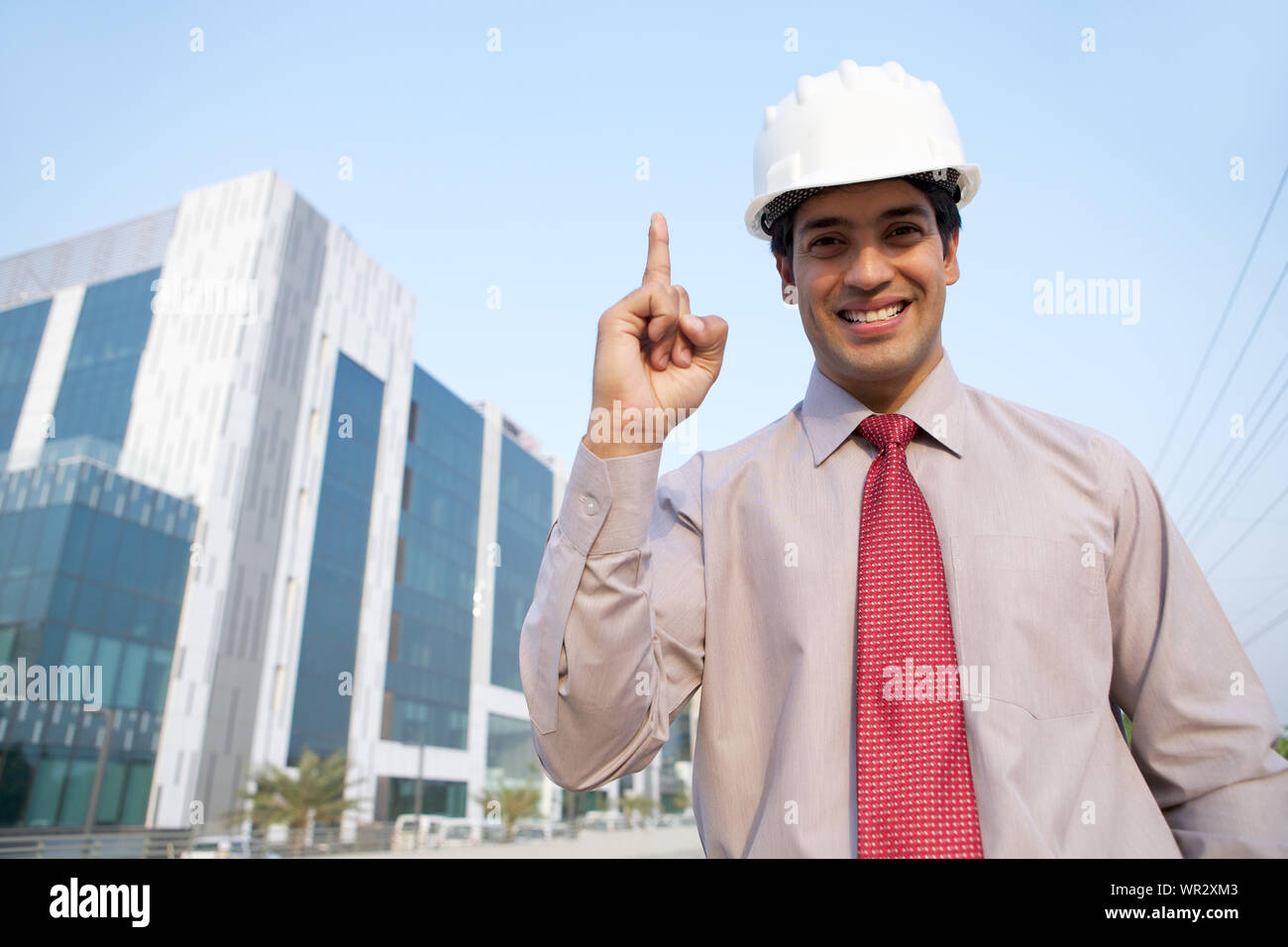 Architect standing and pointing upward Stock Photo - Alamy