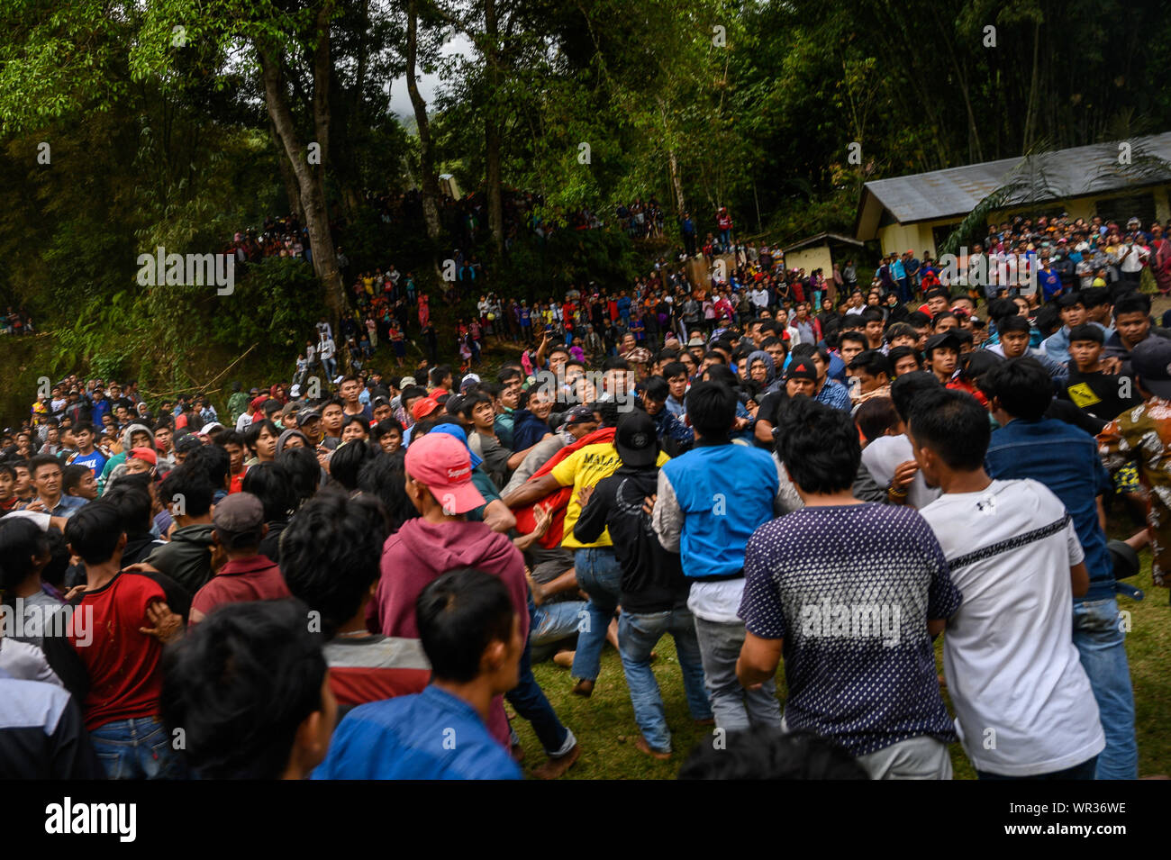 A number of men in action during the tradition in Toraja Utara.Sisemba ...