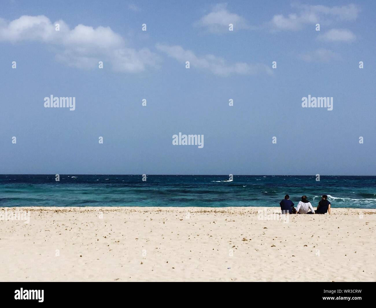 Three men on beach hi-res stock photography and images - Alamy