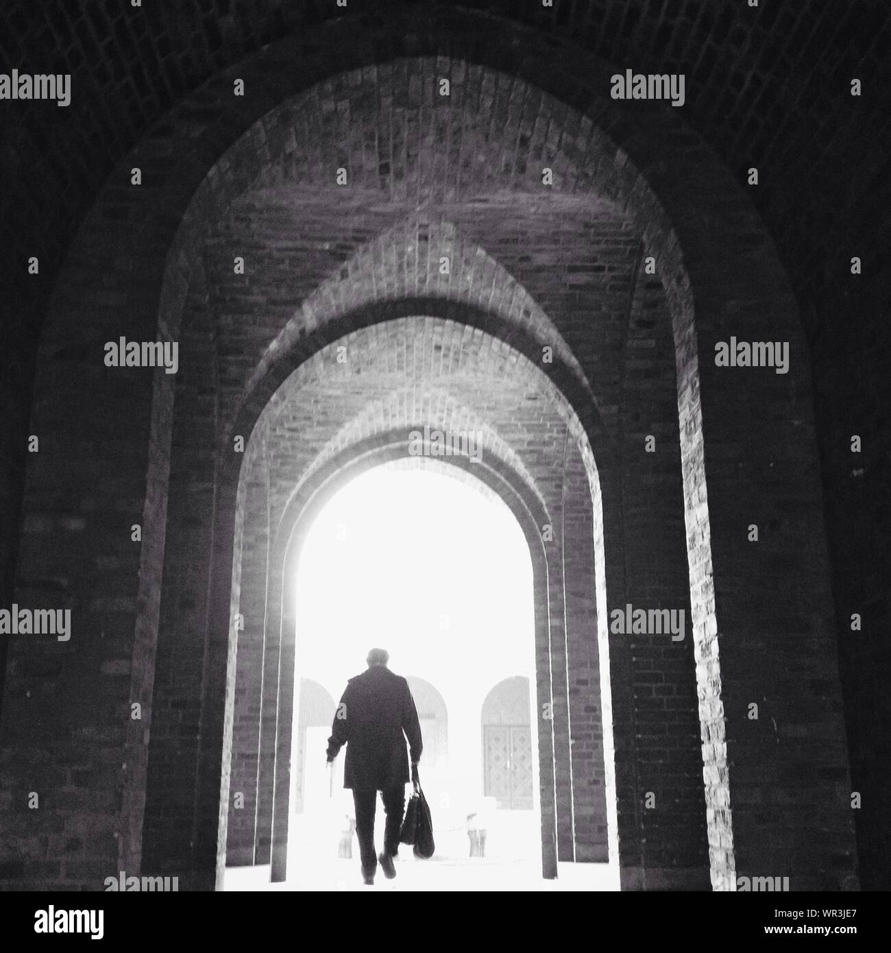 Walking under arch hi-res stock photography and images - Alamy