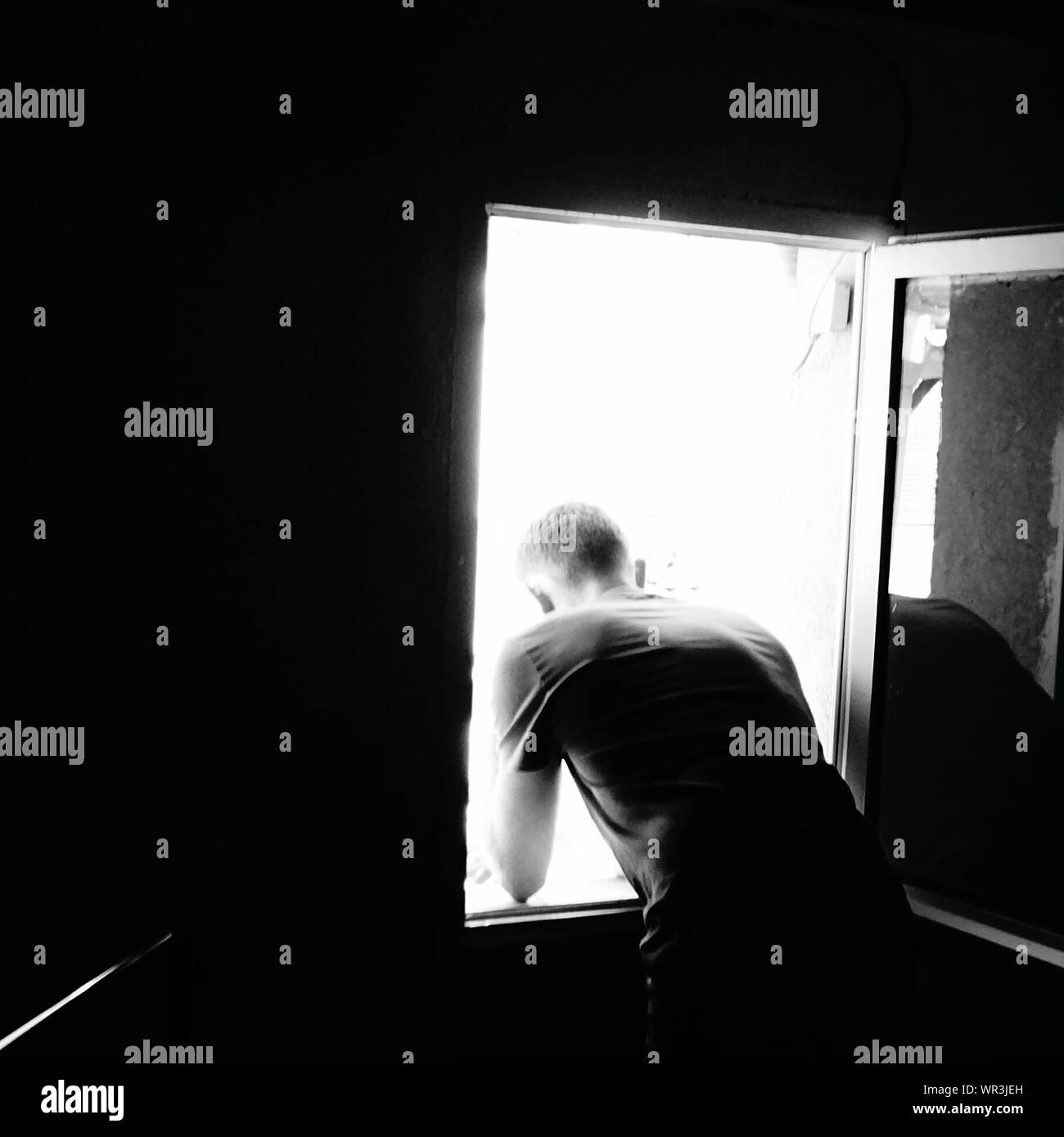 Man leaning on window High Resolution Stock Photography and Images - Alamy
