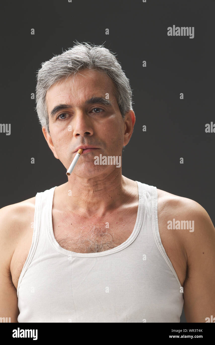 Senior man smoking cigarette Stock Photo - Alamy