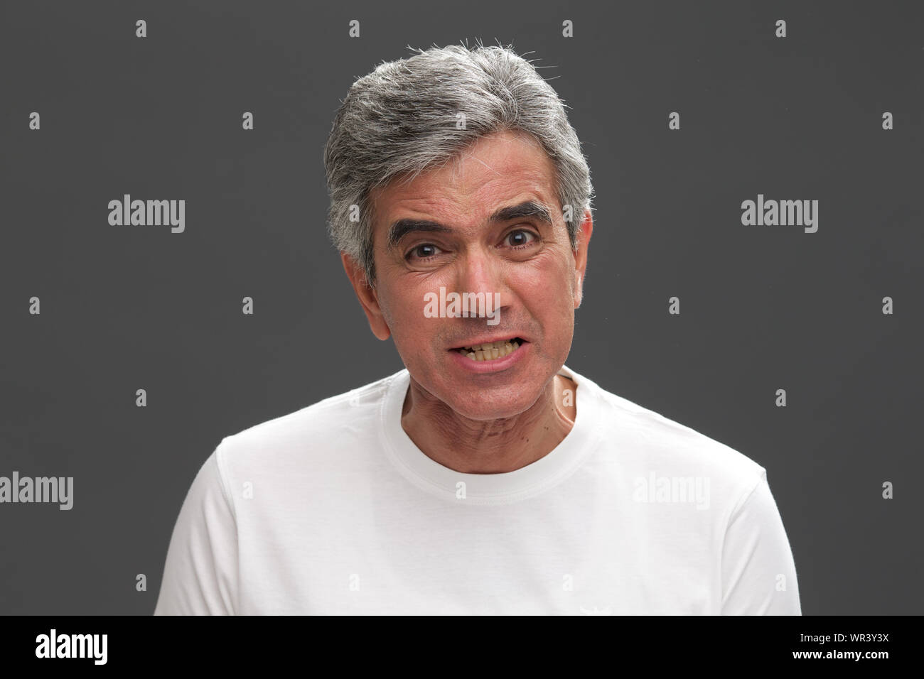 Portrait of a senior man looking angry Stock Photo - Alamy