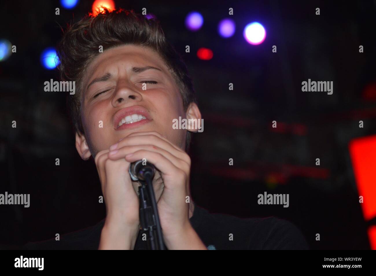 Young Man Singing At Music Concert Stock Photo - Alamy