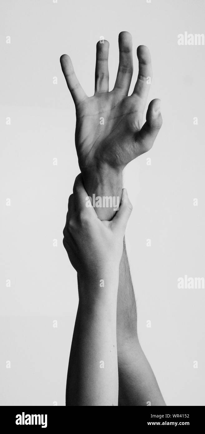 Arms raised holding Black and White Stock Photos & Images - Alamy