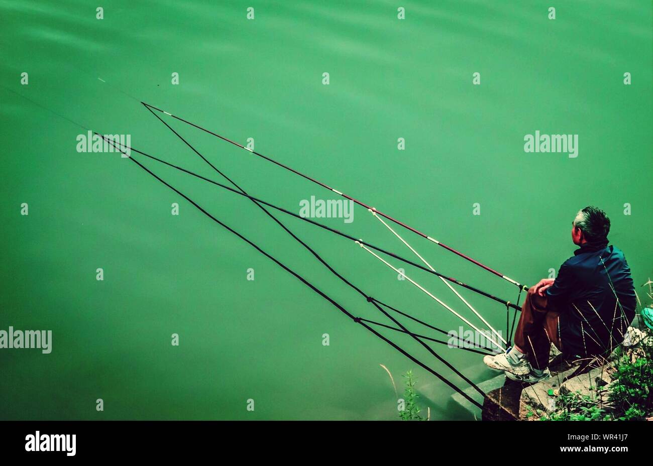 Side View Of A Mature Man Fishing At Sea Stock Photo - Alamy