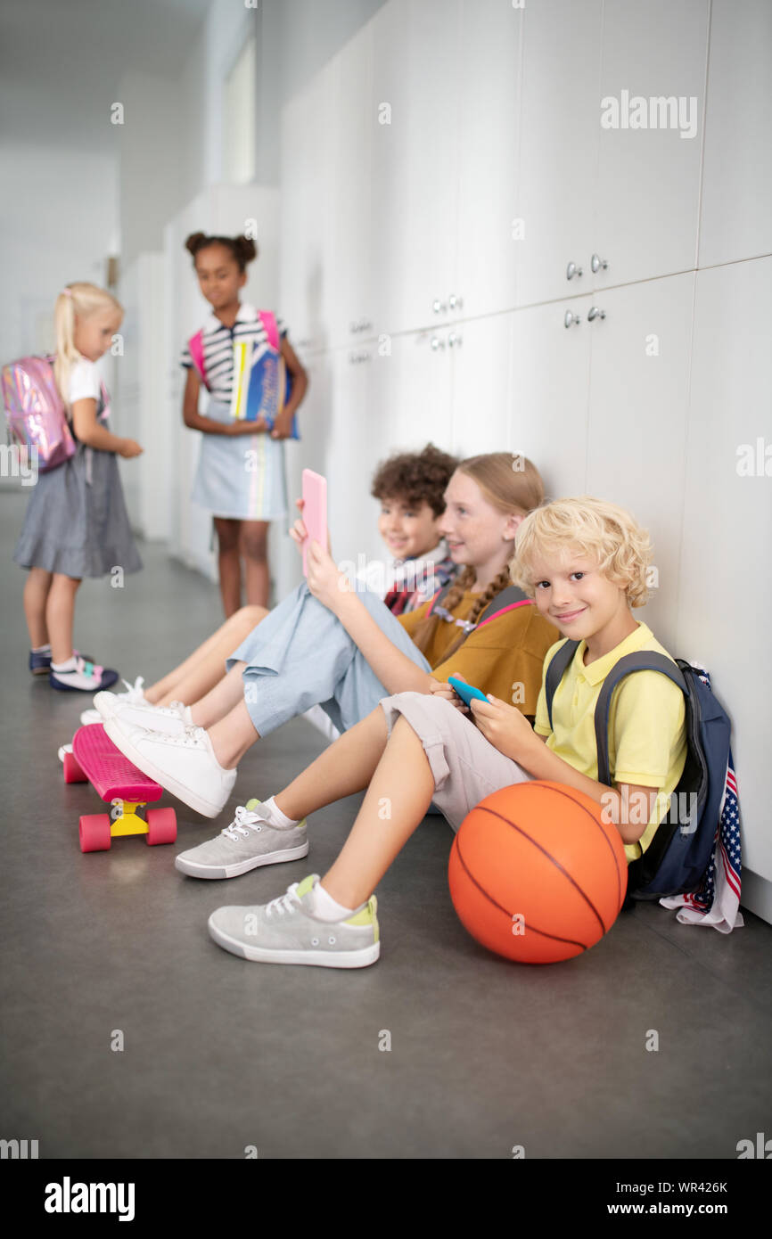 Children enjoying school break playing video games and talking Stock ...