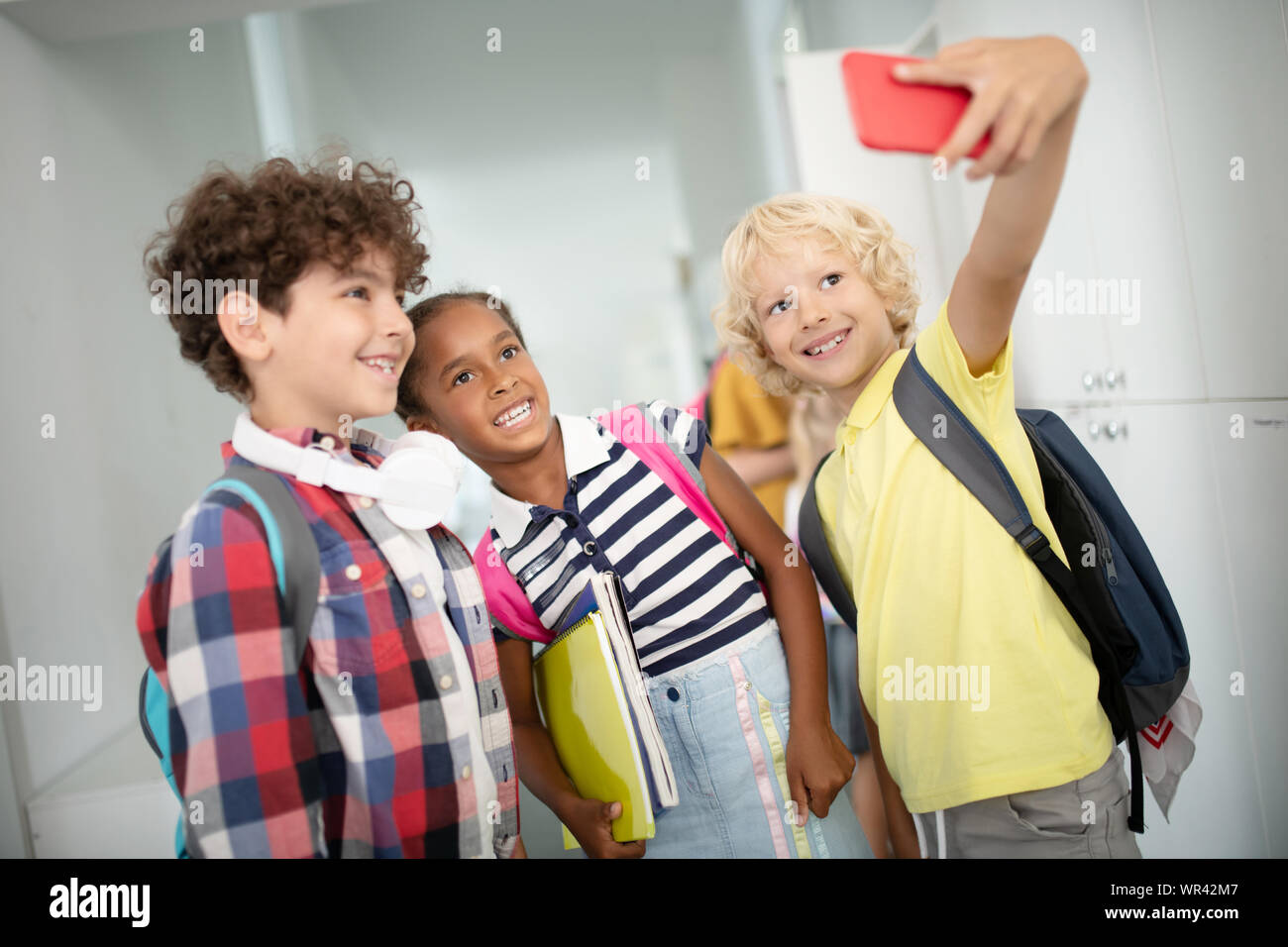 Cheerful pupils smiling while making selfie on school break Stock Photo ...
