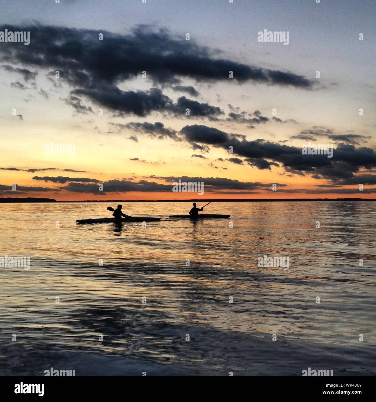 Side View Of Silhouette Boating In Calm Sea Stock Photo - Alamy