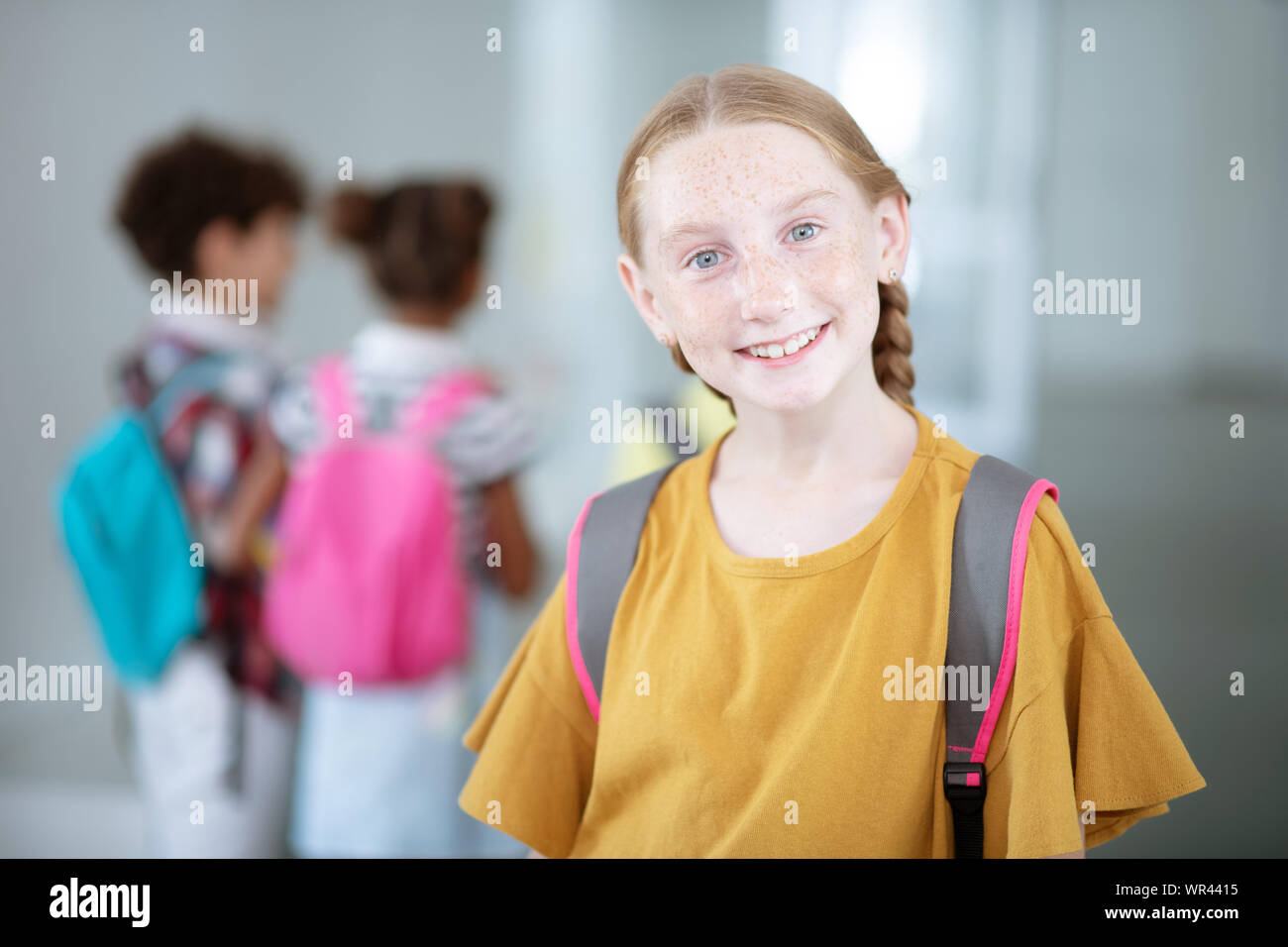 Girl smiling broadly while feeling good at school Stock Photo - Alamy