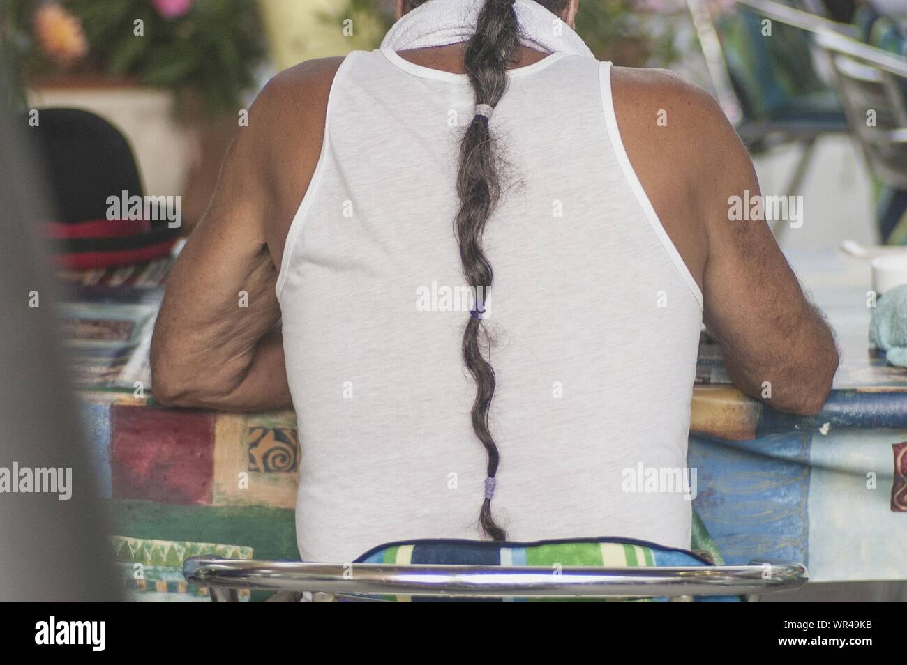 Man with ponytail hi-res stock photography and images - Alamy
