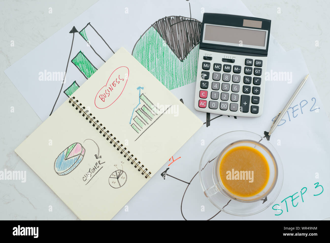 Closed up and soft focus on pen laying on paperwork with calculator for ...